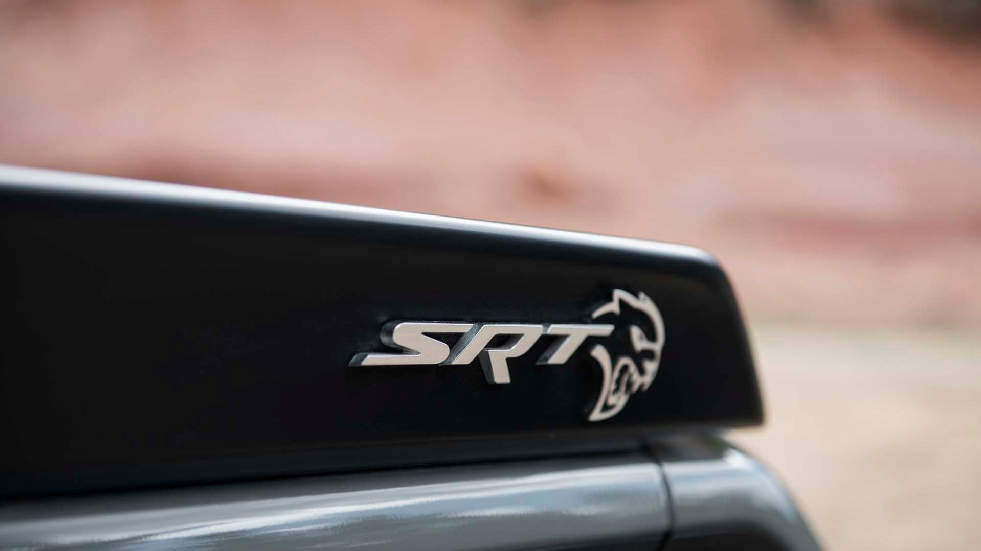 Dodge Challenger Hellcat and Ford F-150 Raptor race around, over a mountain